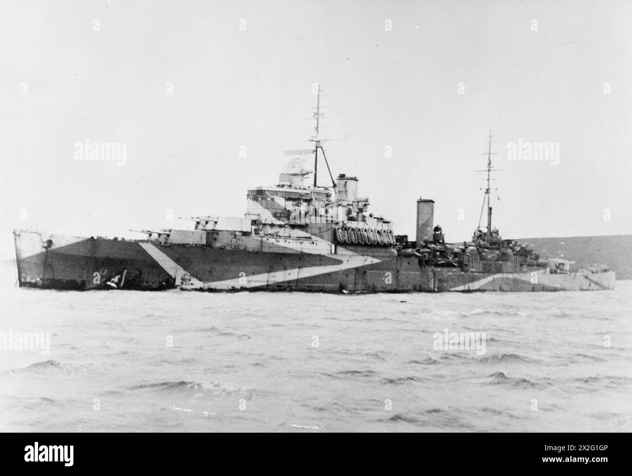 Half bow view of the Mauritius-class British cruiser HMS Uganda ...