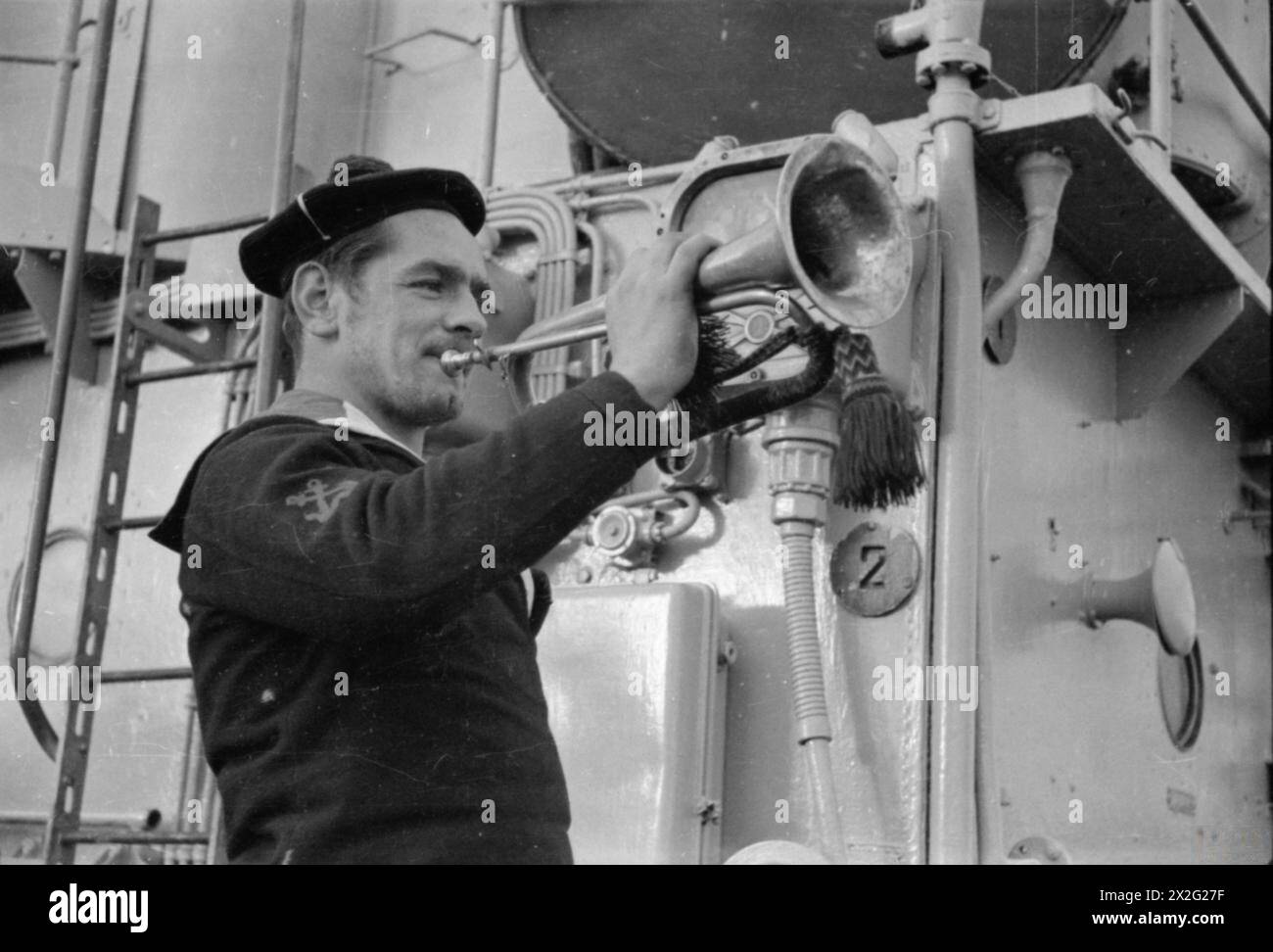 In 1940 or 1941, Free French sailors aboard a destroyer sound the bugle ...