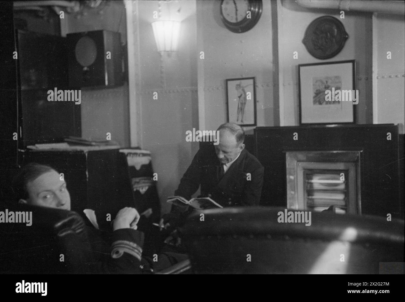 Officers are seated in the ward room of the Royal Navy destroyer HMS ...