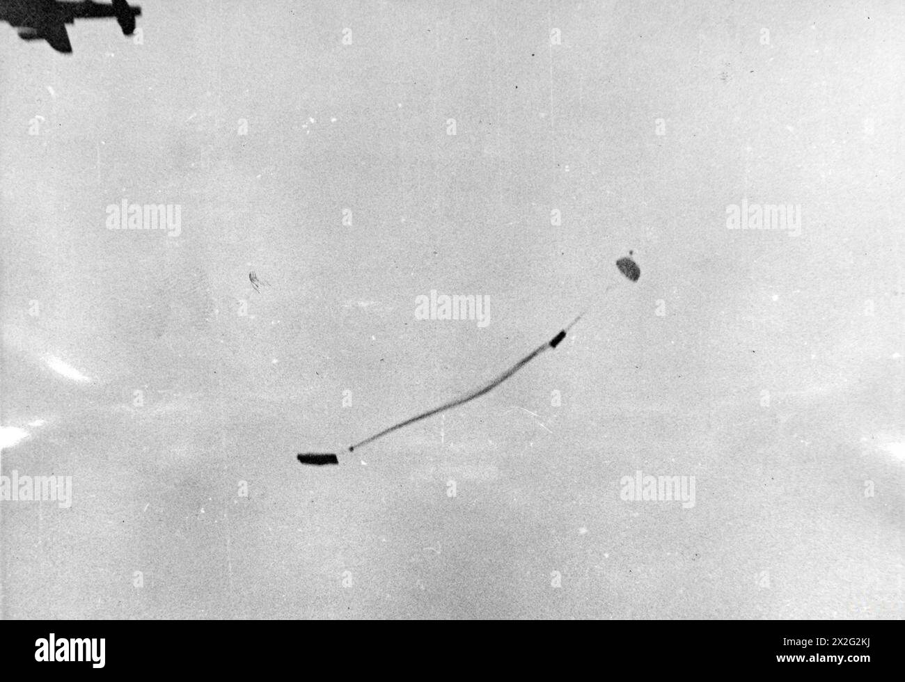 An airborne lifeboat is dropped from a Lancaster aircraft by parachute ...