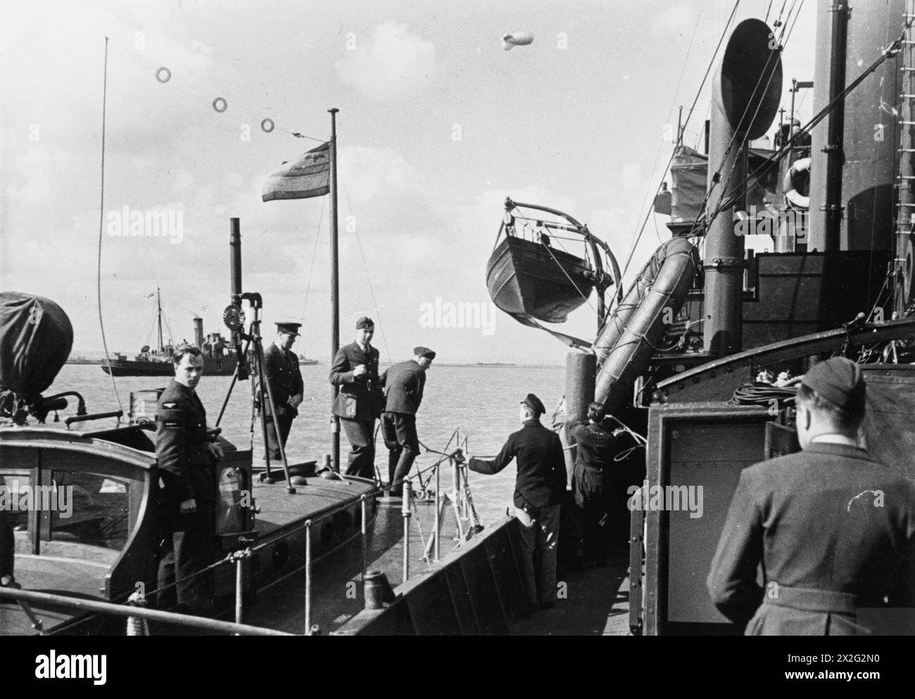 CONVOY PREPARING TO SAIL. 1940, CHATHAM. - RAF launch comes alongside ...