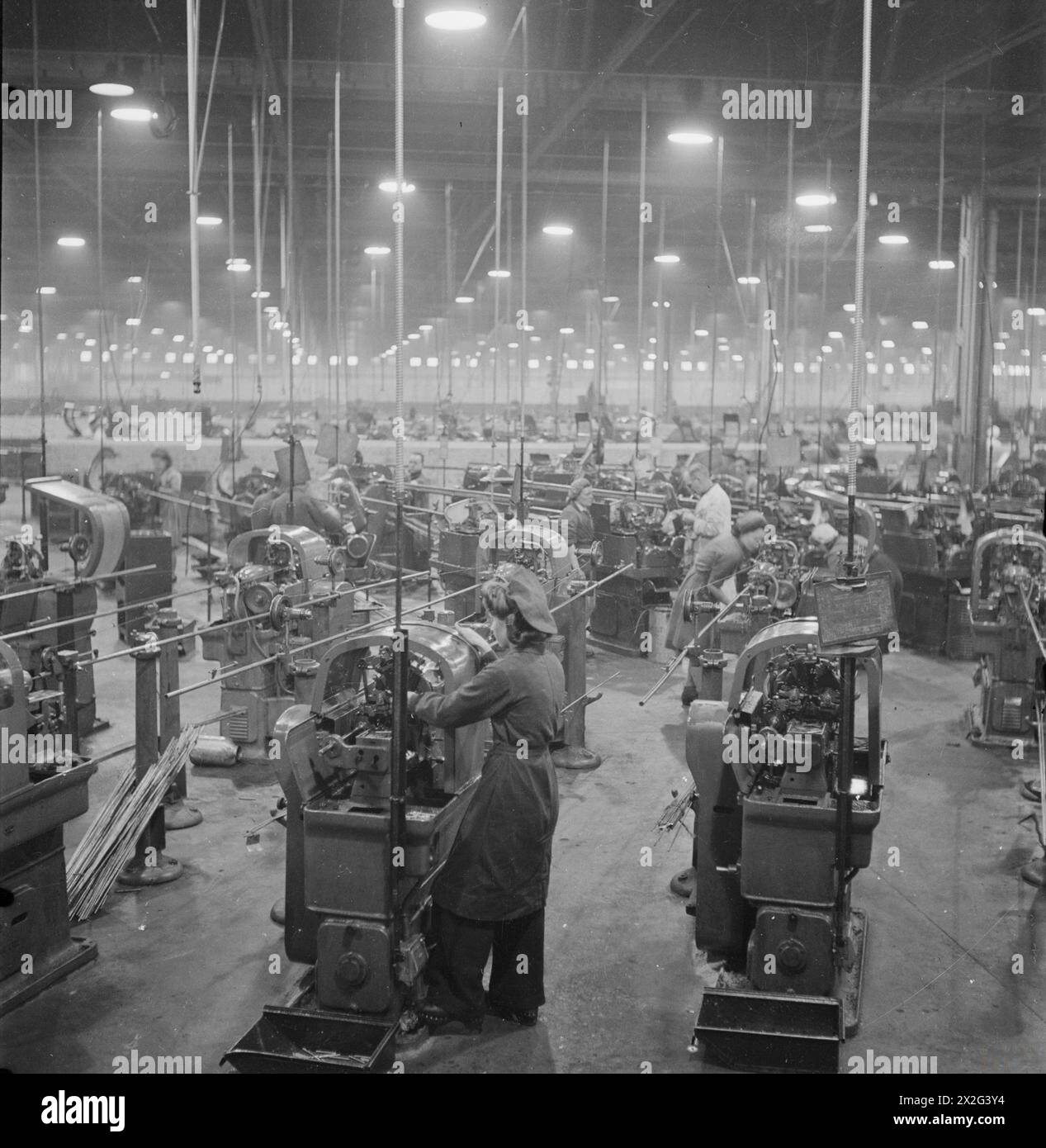 AIRCRAFT ENGINE PRODUCTION IN BRITAIN, C 1943 - Men and women work on ...
