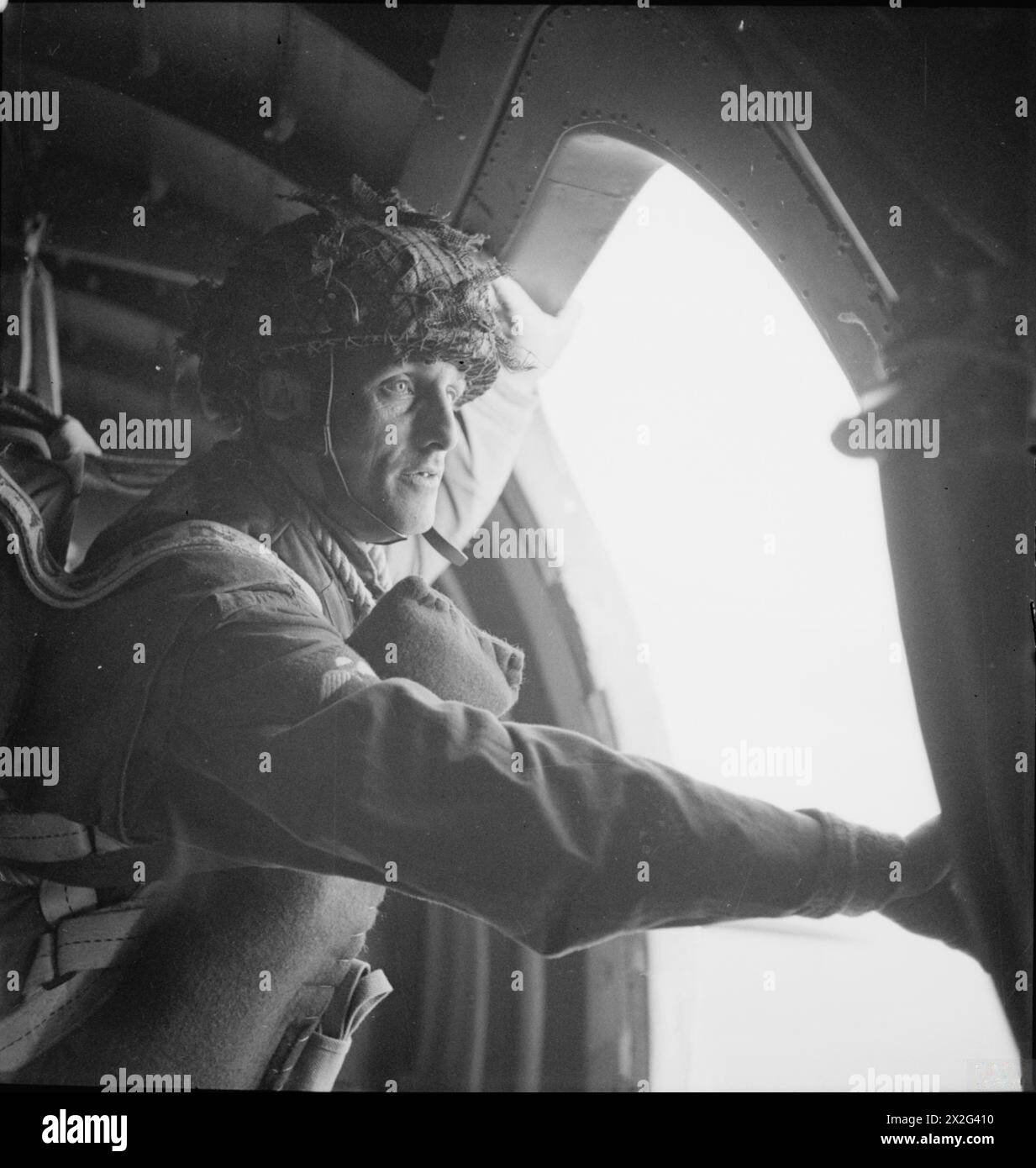 Photograph depicting a British paratrooper standing at the door of a ...