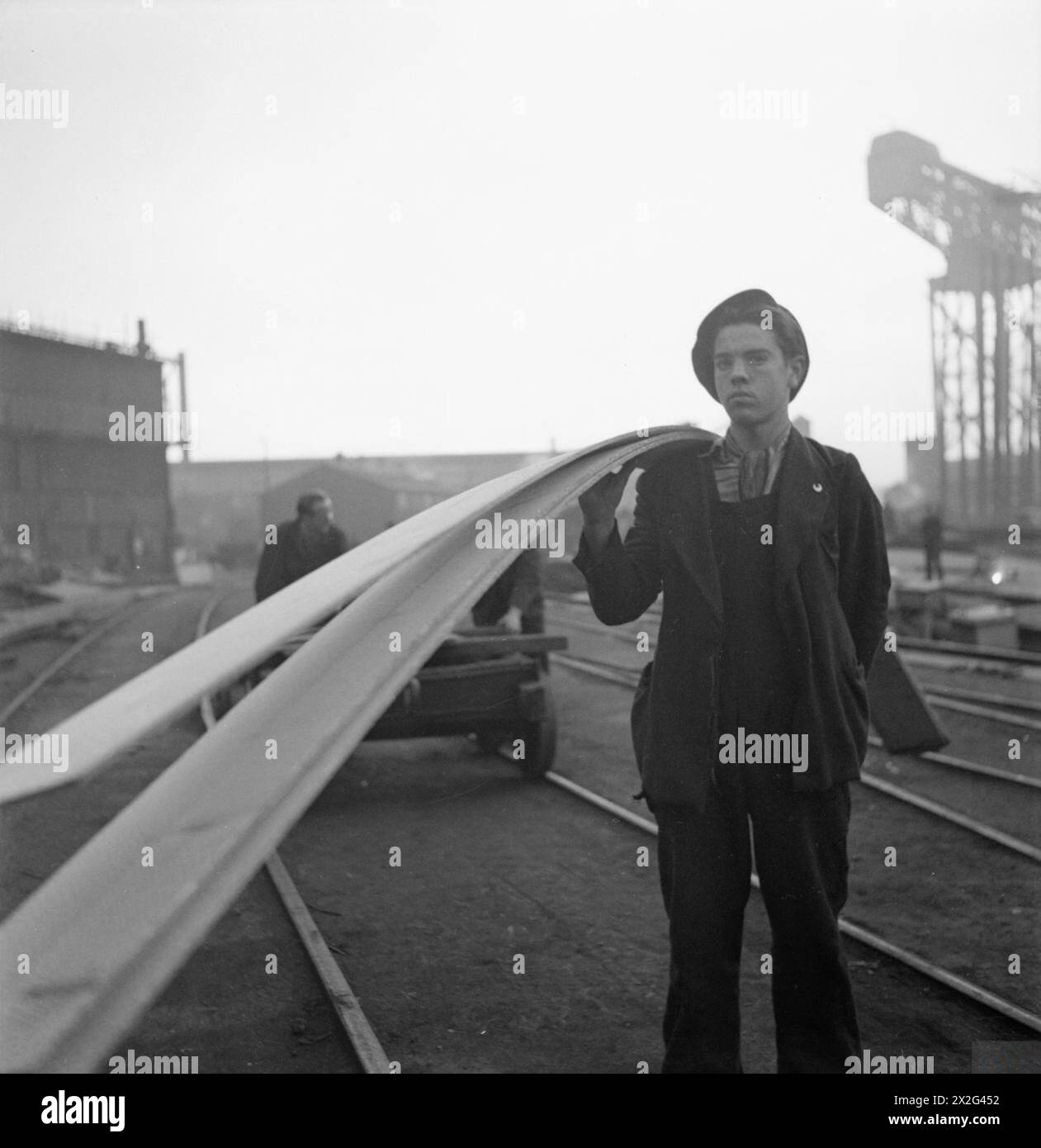 CECIL BEATON PHOTOGRAPHS: TYNESIDE SHIPYARDS, 1943 - A boy carrying ...
