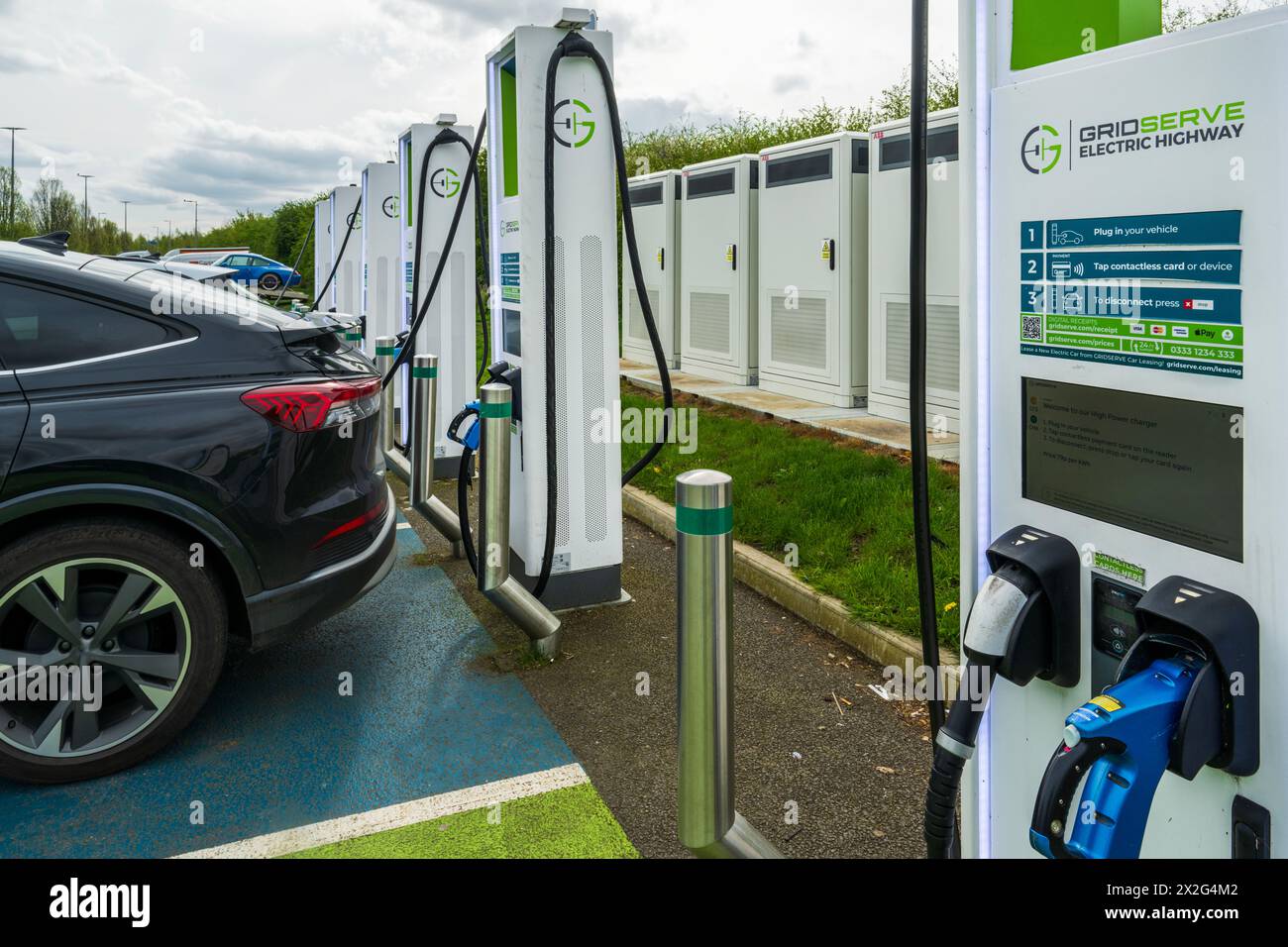 Cars at electric vehicle recharging station, part of the Gridserve ...