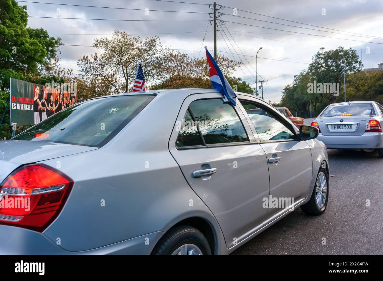 modern car with flags of cuba and usa, boyeros avenue Stock Photo - Alamy