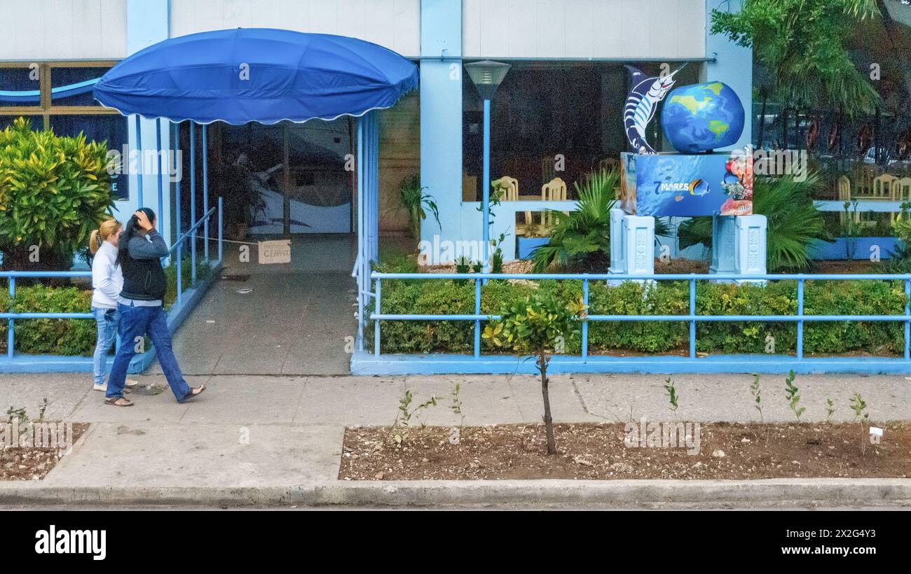 Two cuban women walking by a Pescavilla building Stock Photo - Alamy