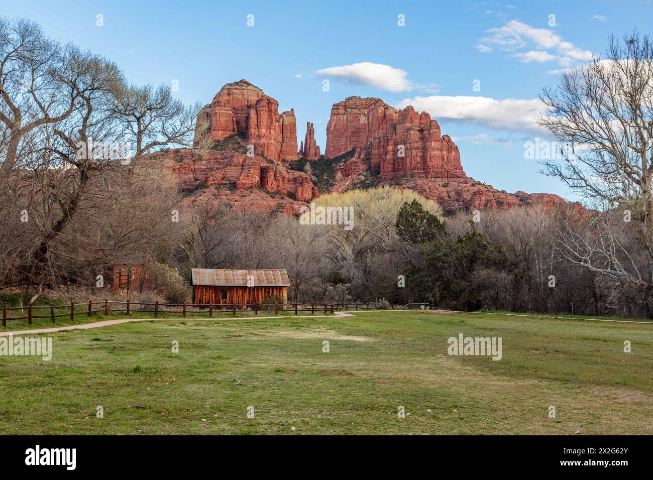 Cathedral Rock sandstone formations tower over a rustic barn at the ...