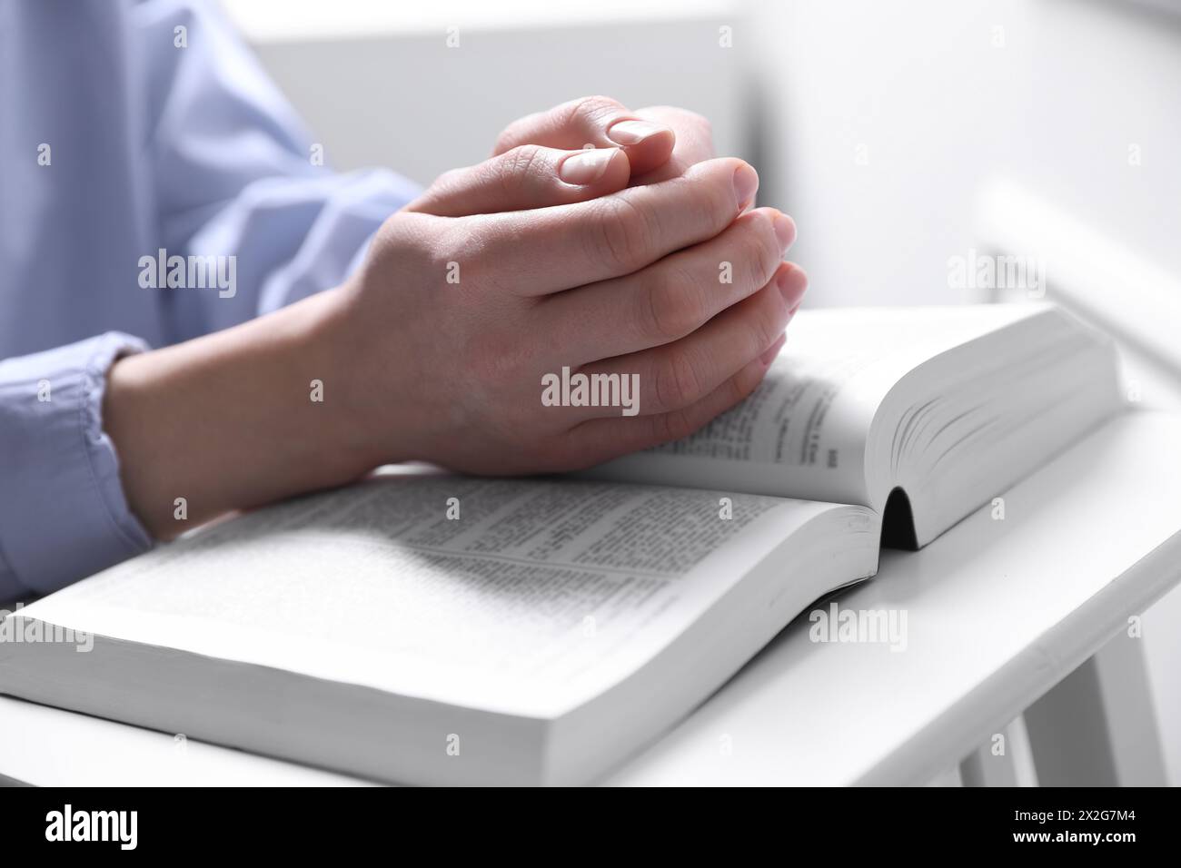 Religion. Christian woman praying over Bible indoors, closeup Stock ...