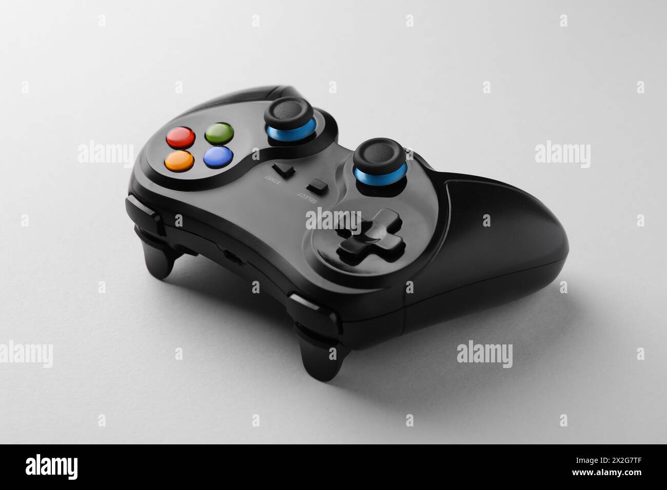Black wireless game controller on light grey background Stock Photo - Alamy