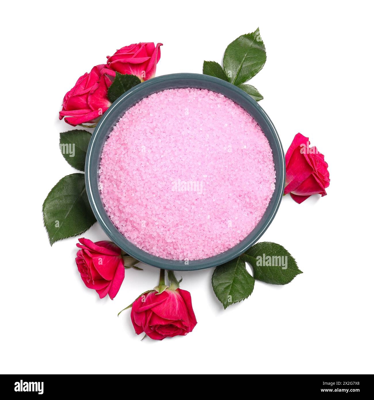Pink sea salt in bowl, roses and green leaves isolated on white, top ...