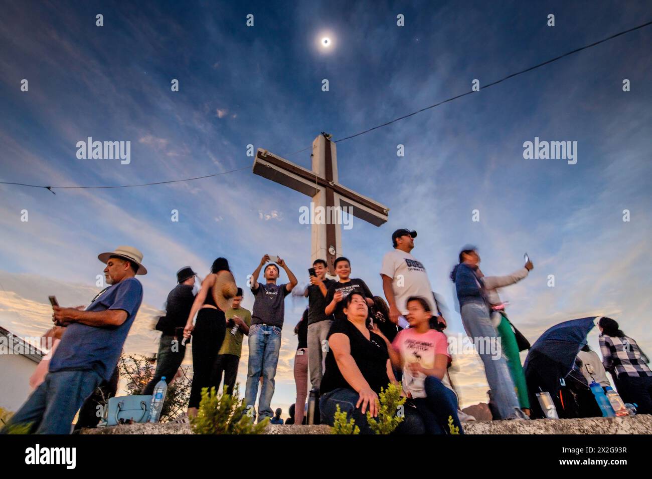 Eclipse watchers gather around cross , Nazas Mexico Stock Photo - Alamy