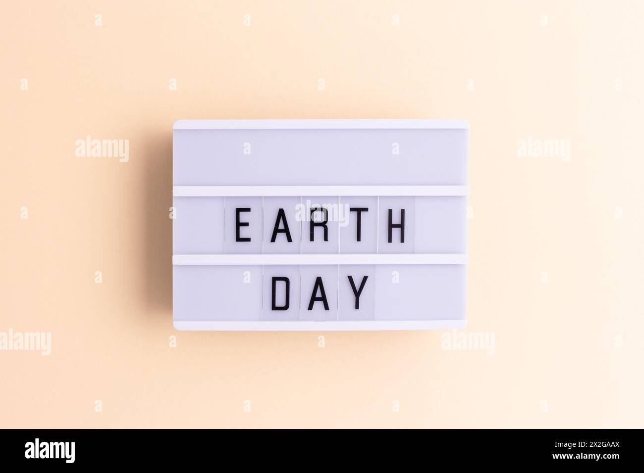 Earth day. White lightbox with letters on a beige background Stock ...
