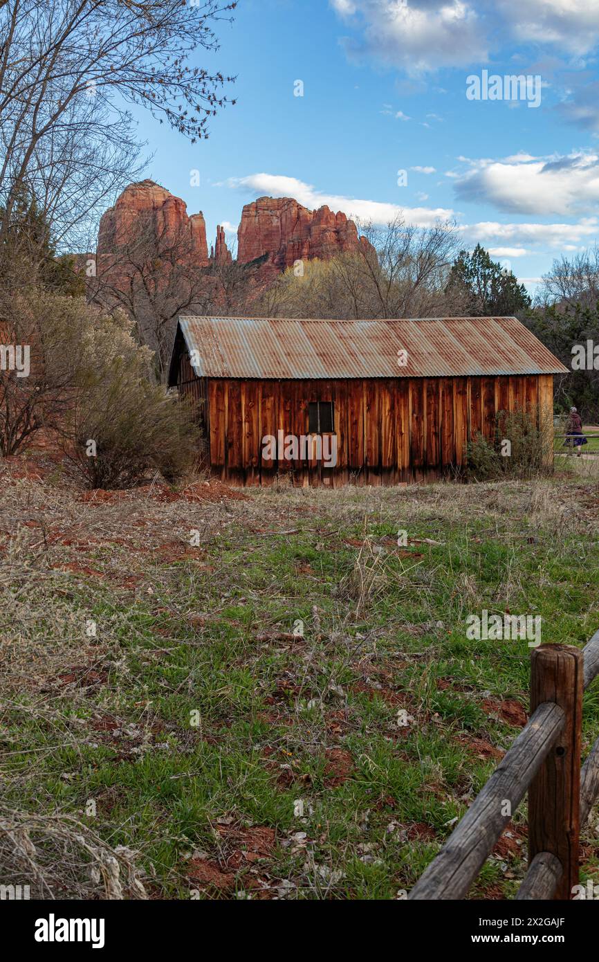 Cathedral Rock sandstone formations tower over a rustic barn at the ...