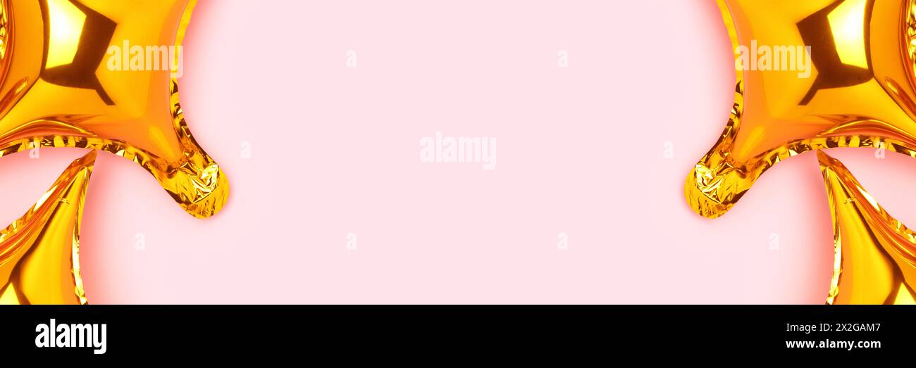 Frame made of gold colored shiny star balloons on a pink background ...