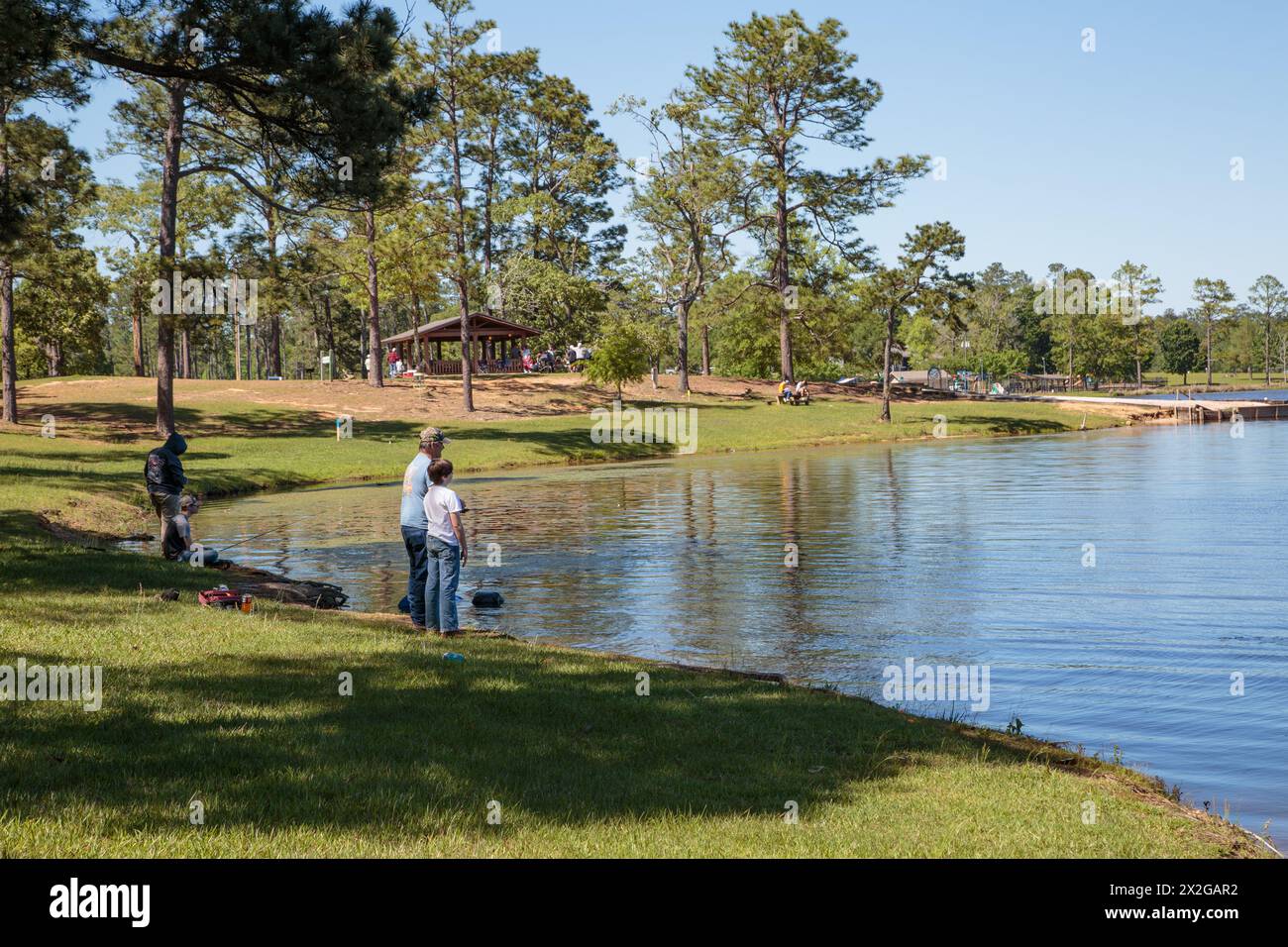 Grandfather and grandson fishing on shoreline of Geiger Lake at Paul B ...