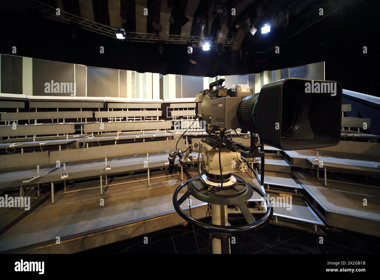 professional black video camera in television studio, seats for ...