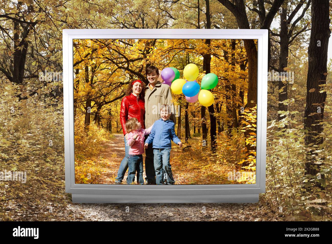 family of four with balloons and Footpath among yellowed trees in ...