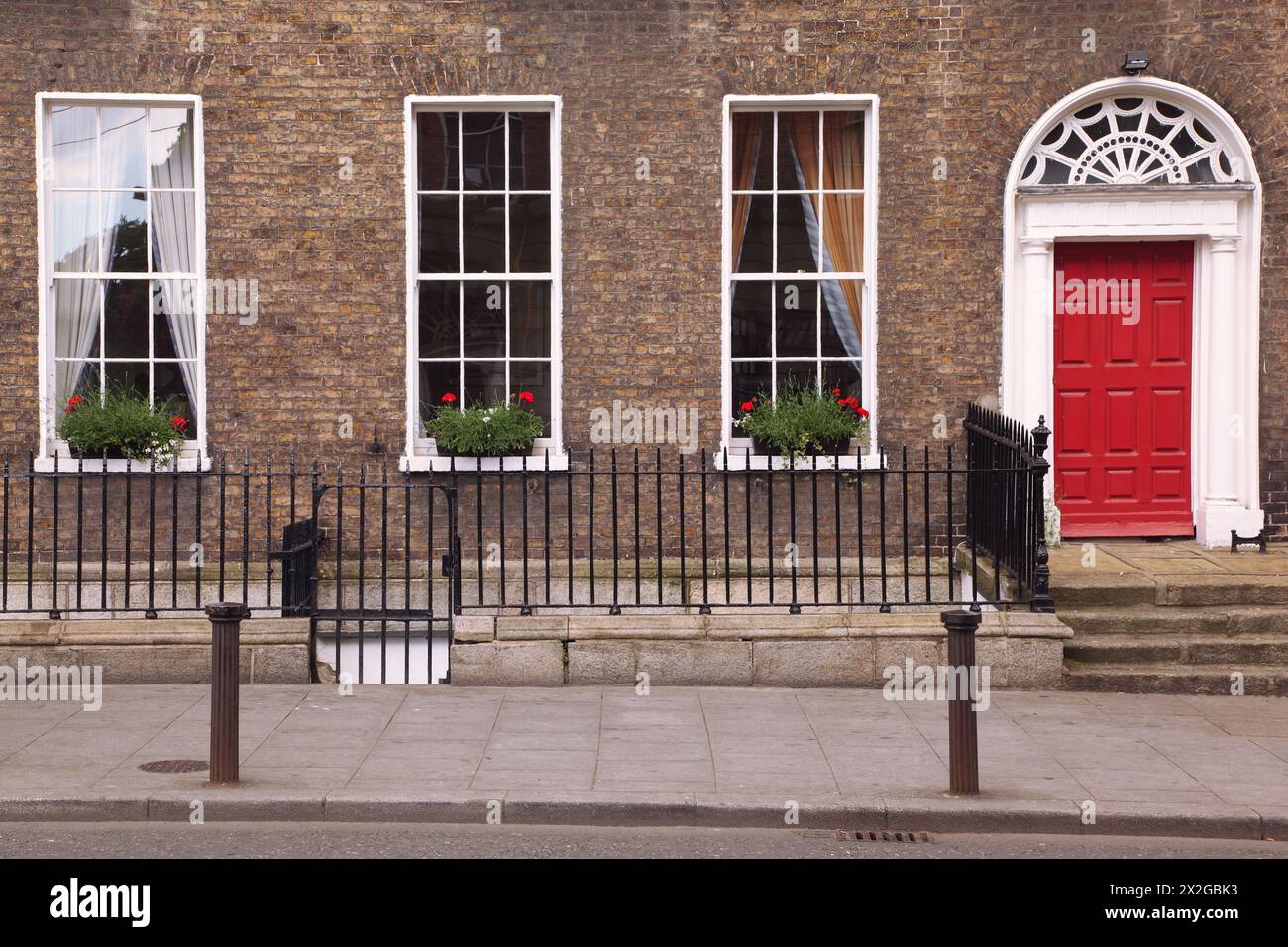 first floor and entrance to beautiful building, red door, three windows ...