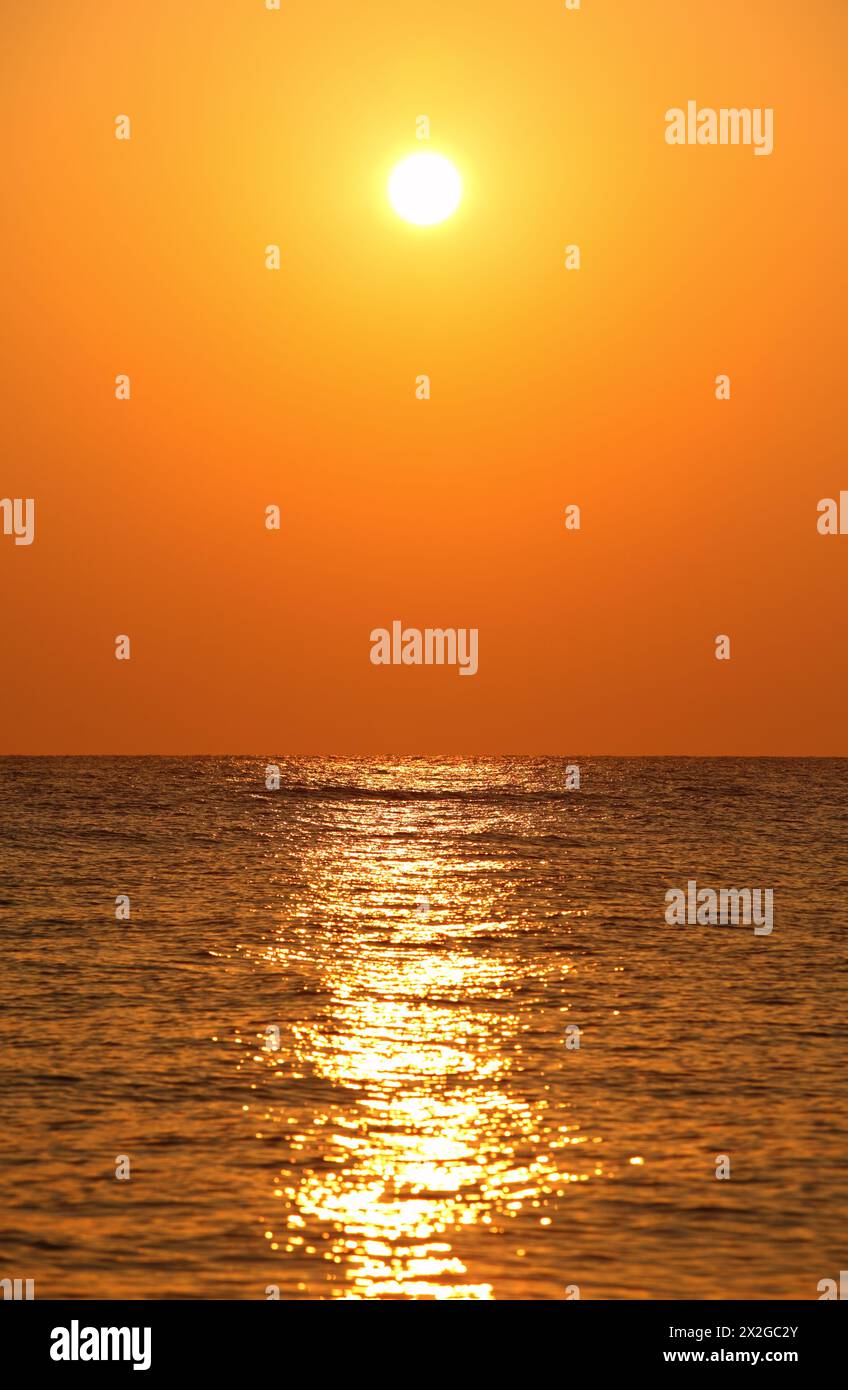 sun sets over horizon, sea, orange sun’s reflection in sea water Stock ...