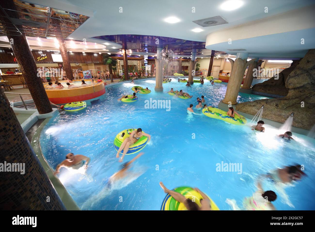 MOSCOW - MARCH 21: People swim on inflatable circles in pool and in ...