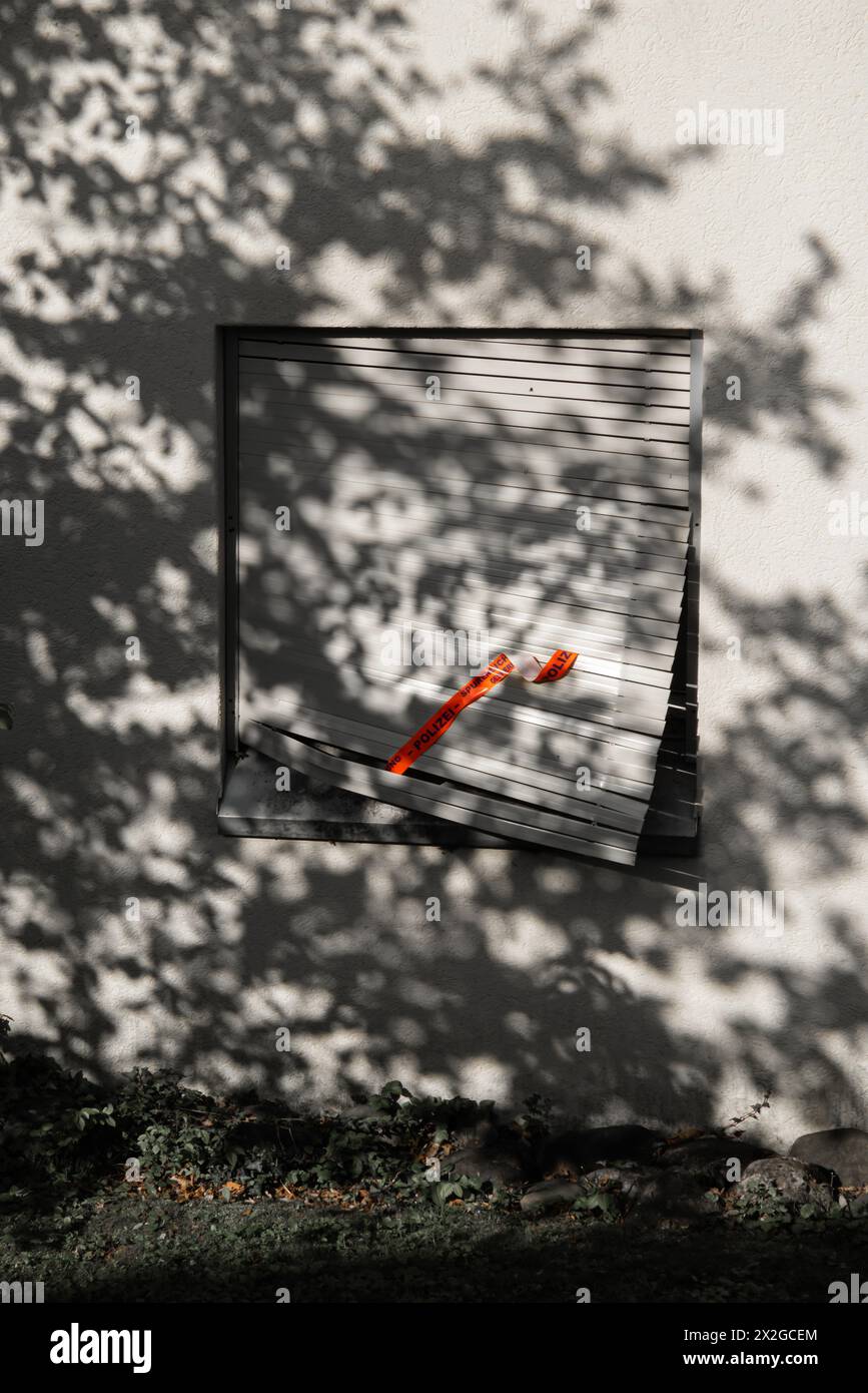 Vandalism - breaking in through a window in a residential building ...