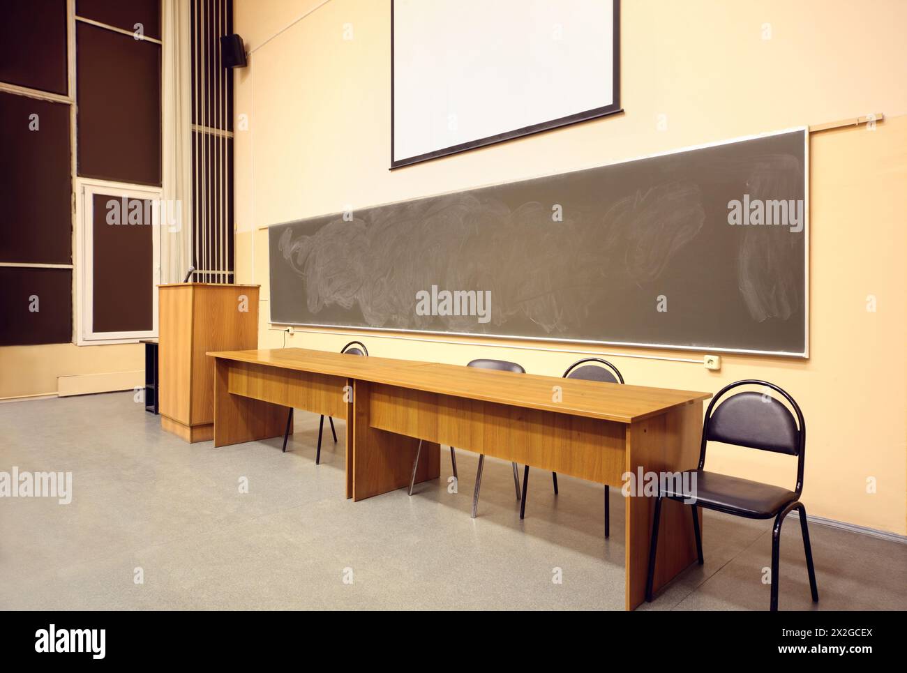 Large classroom, big blackboard, wooden table and black chairs Stock ...