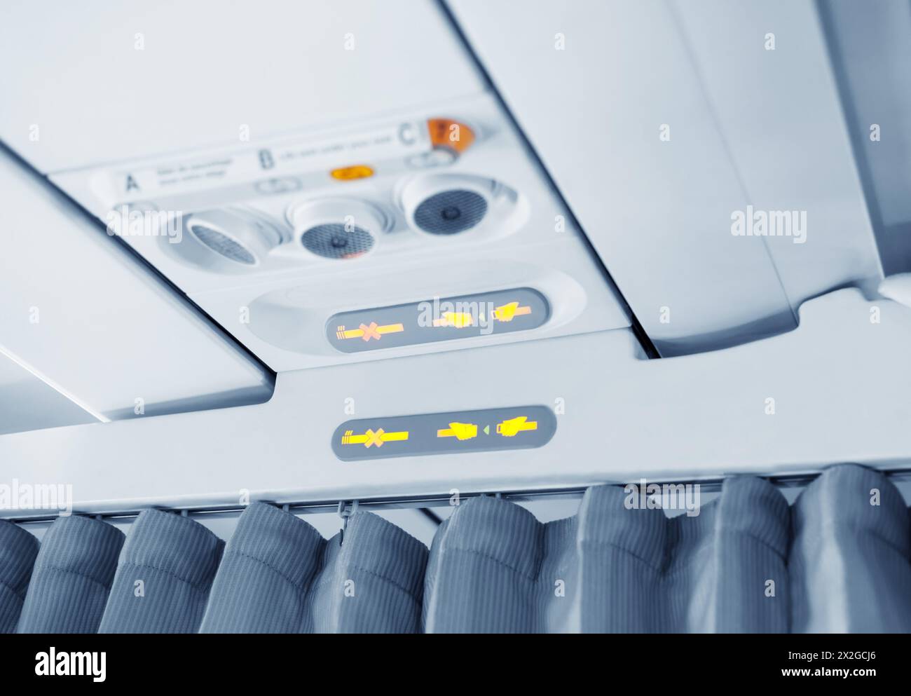 Curtain between cabins of the airplane. Information signs about locking ...