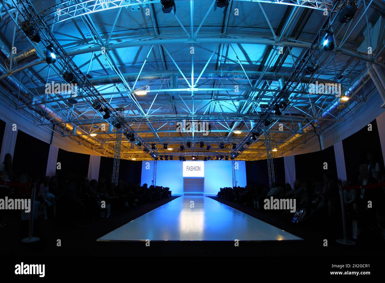 podium before showing new collection of clothing, dark silhouettes of ...