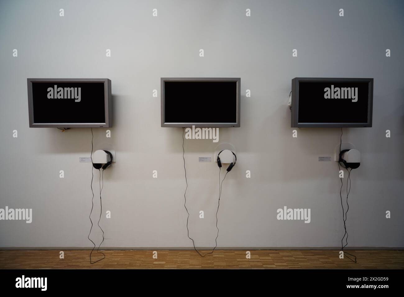 Monitors and headphones on the wall Stock Photo - Alamy