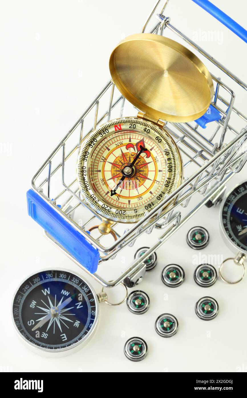 big golden compass in cart and ten black compasses isolated on white ...
