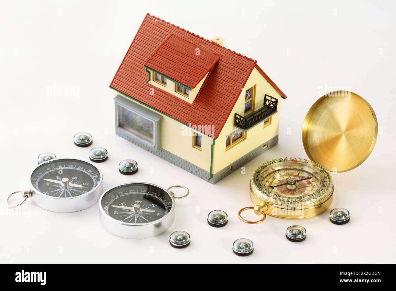 toy house with red roof and eleven different compasses isolated on ...