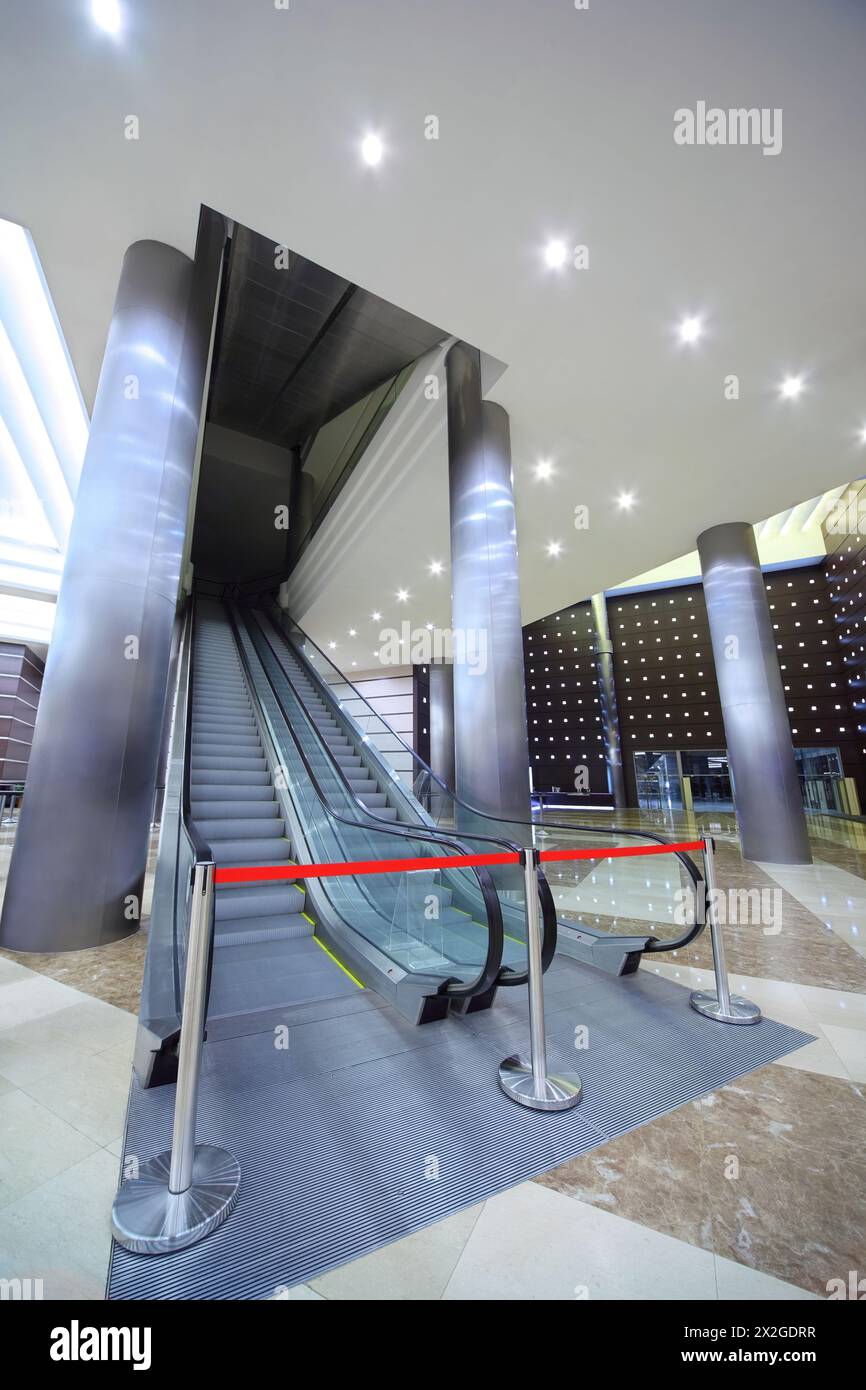 Escalator in large hall which is closed barrier Stock Photo - Alamy