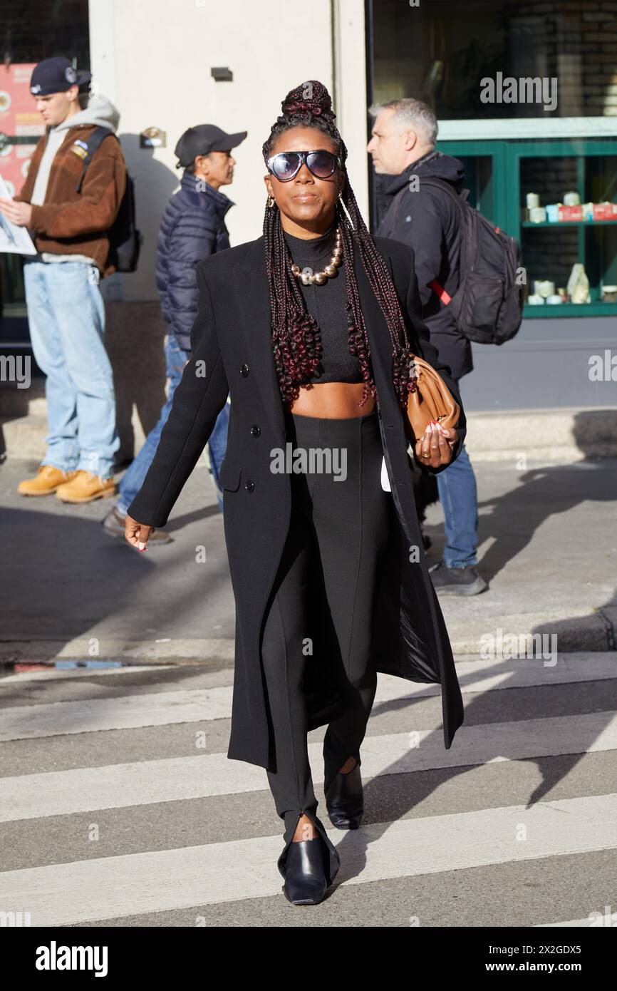 MILAN, ITALY - FEBRUARY 24 , 2024: Woman with black jacket, trousers ...