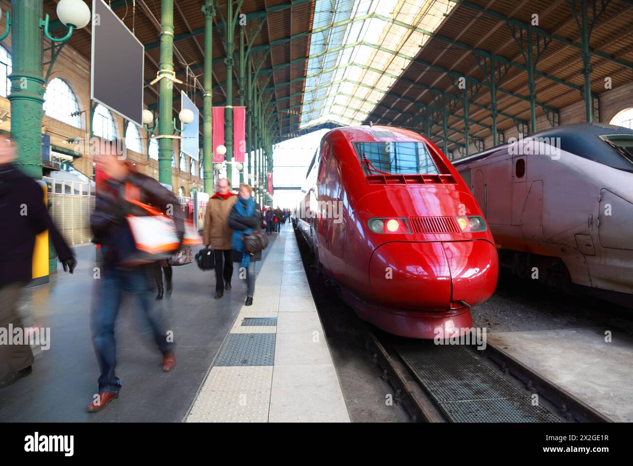 people go on perron, red and gray passenger trains, railway station in ...