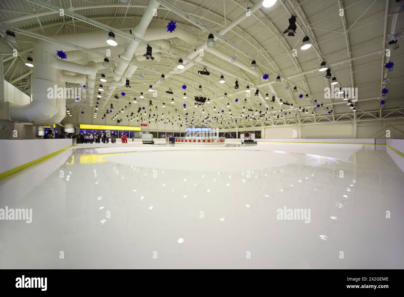 large light indoor ice rink, people, service personnel, polished ice ...