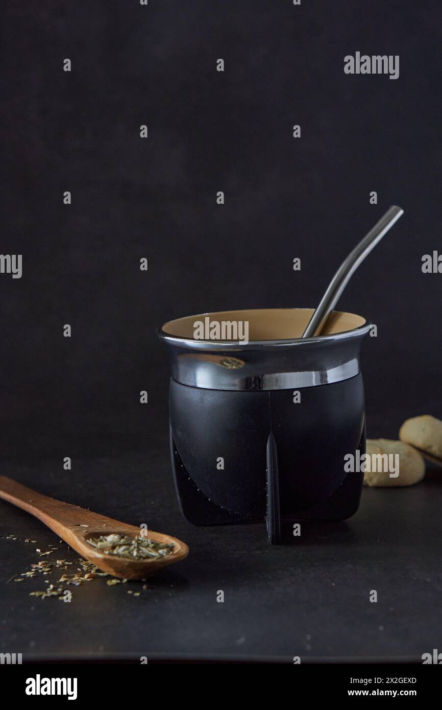 Yerba mate herb and calabash gourd with steel bombilla with a wooden ...