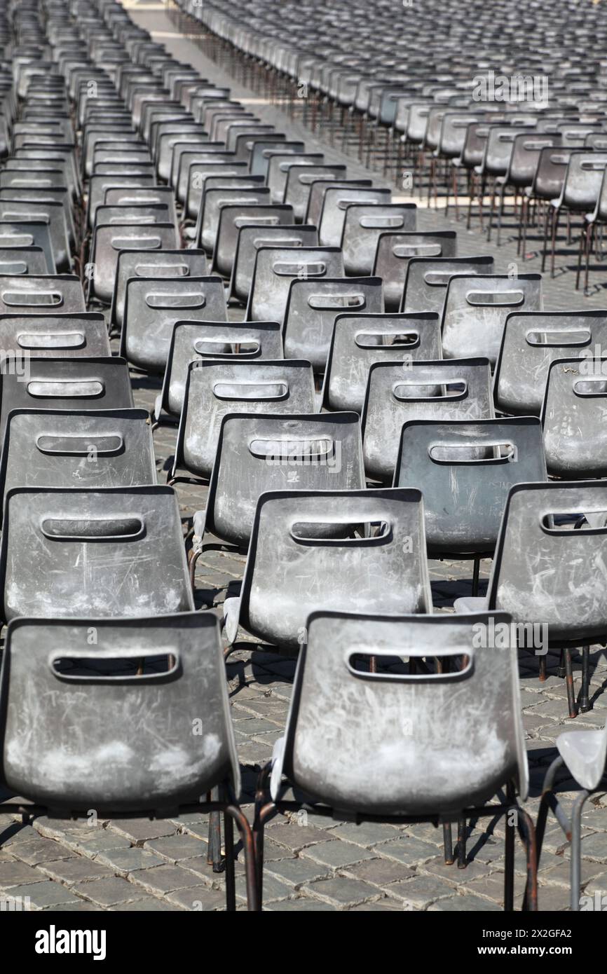 Many rows of gray, plastic chairs outdoor Stock Photo - Alamy
