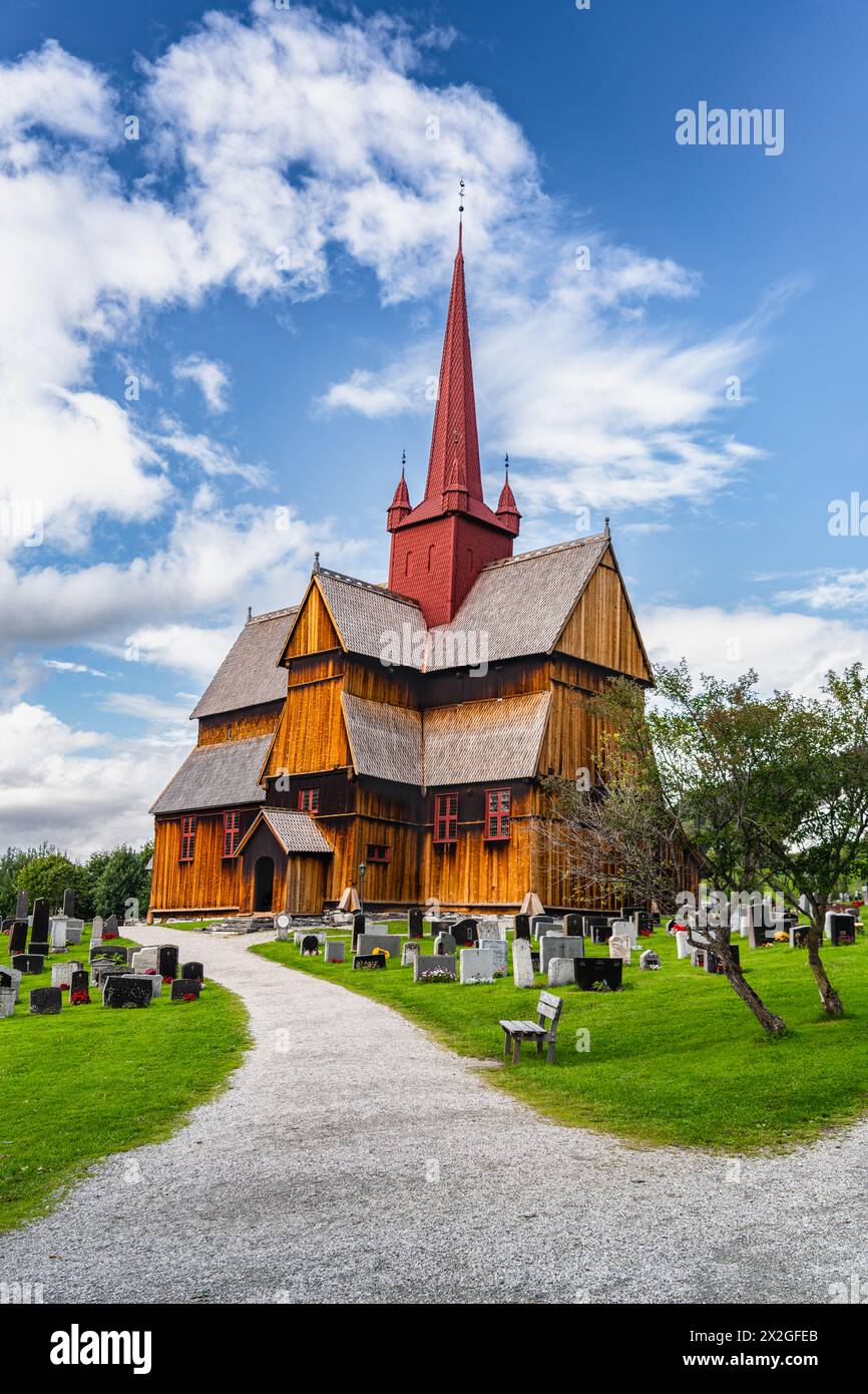 View of the historic Ringebu Stave Church stands amidst headstones ...