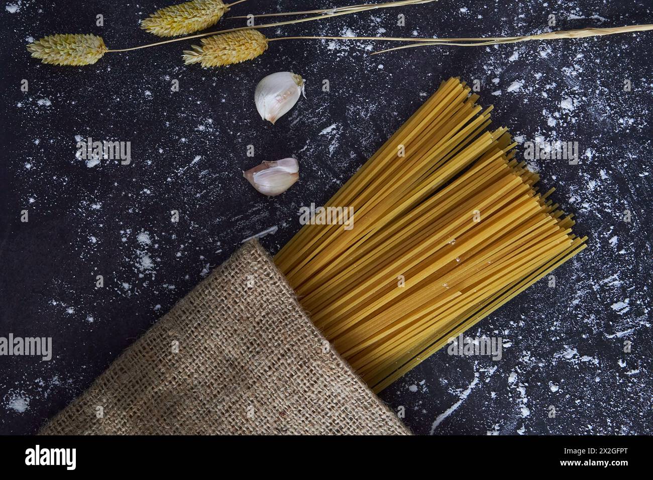zenithal shot of a bunch of dried spaghetti inside a rustic bag on a ...