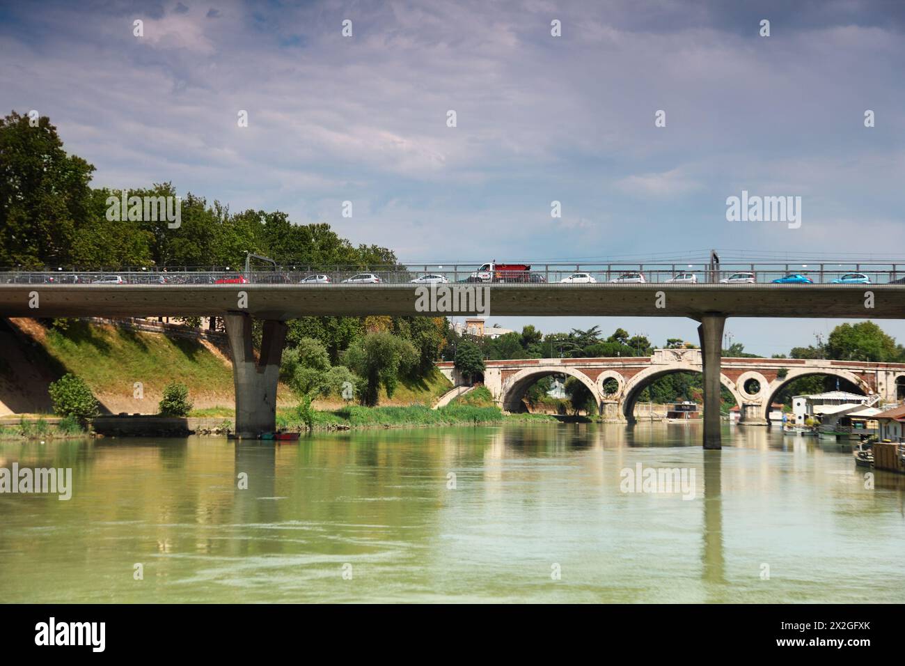 cars go over bridge on Tiber River, away bridge Trastevere in Rome ...