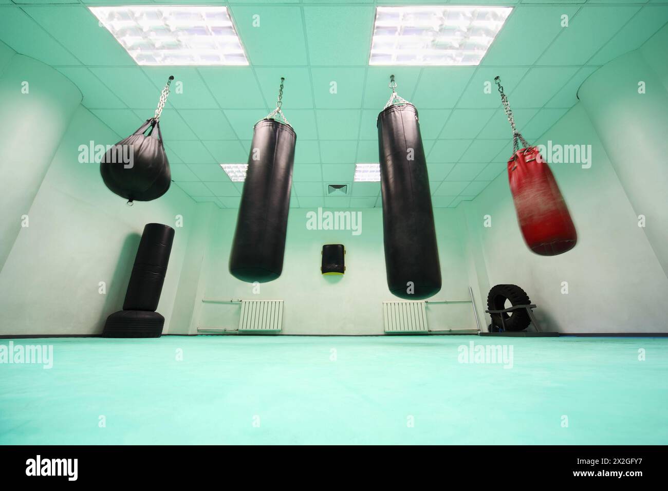 empty light green room, where black and red punching bag hang Stock ...