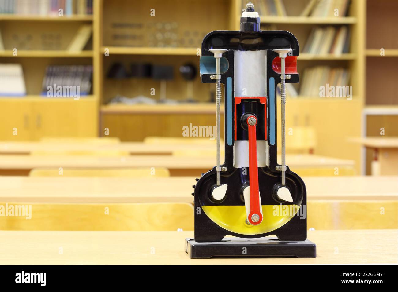 Model of internal combustion engine on desk in empty physics school ...