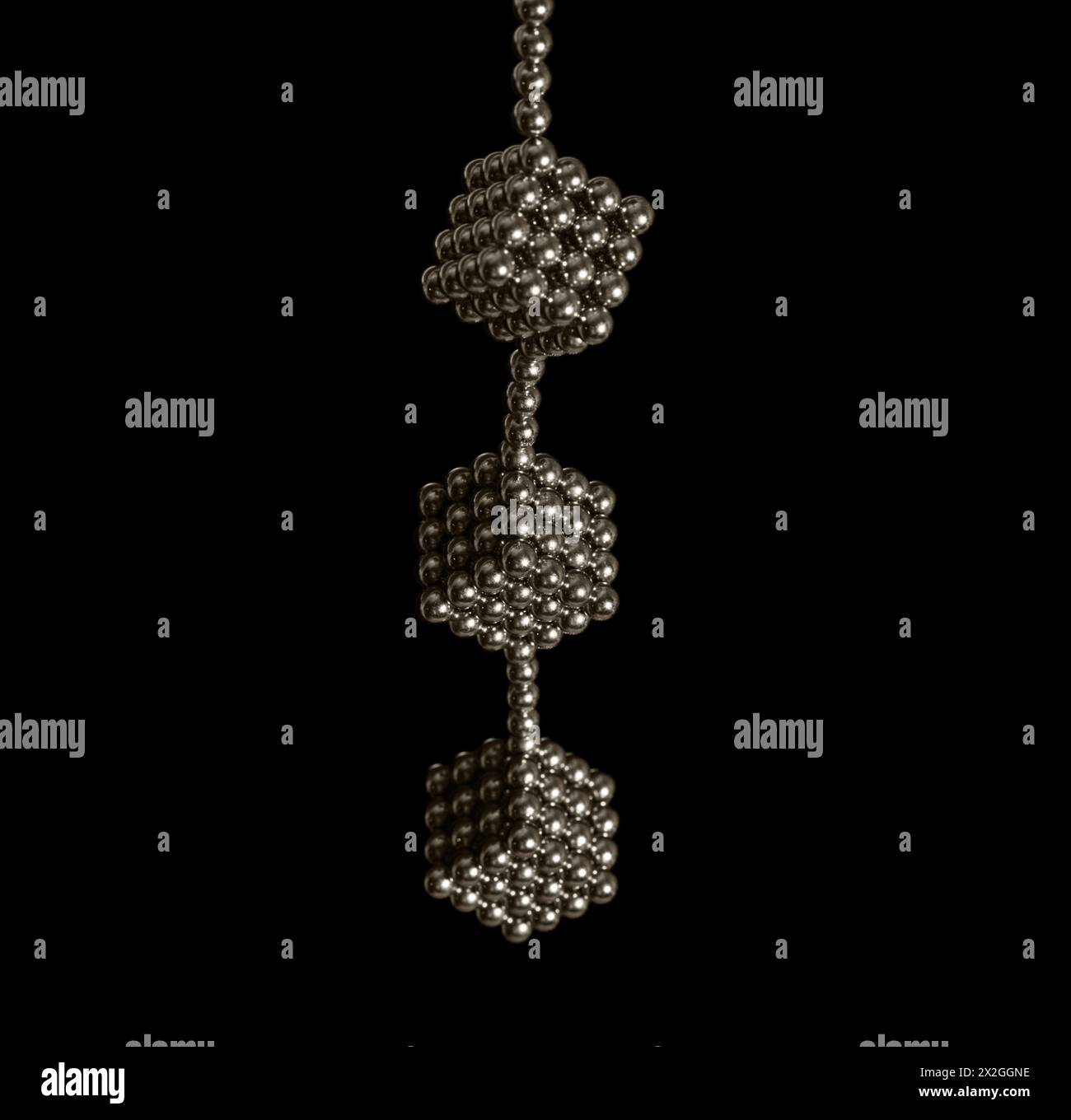 three compounds cubes of metal balls isolated on black background ...