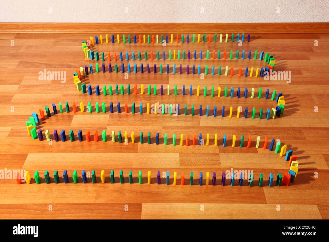 Curved series of multi-colored plastic parts of constructor on floor ...