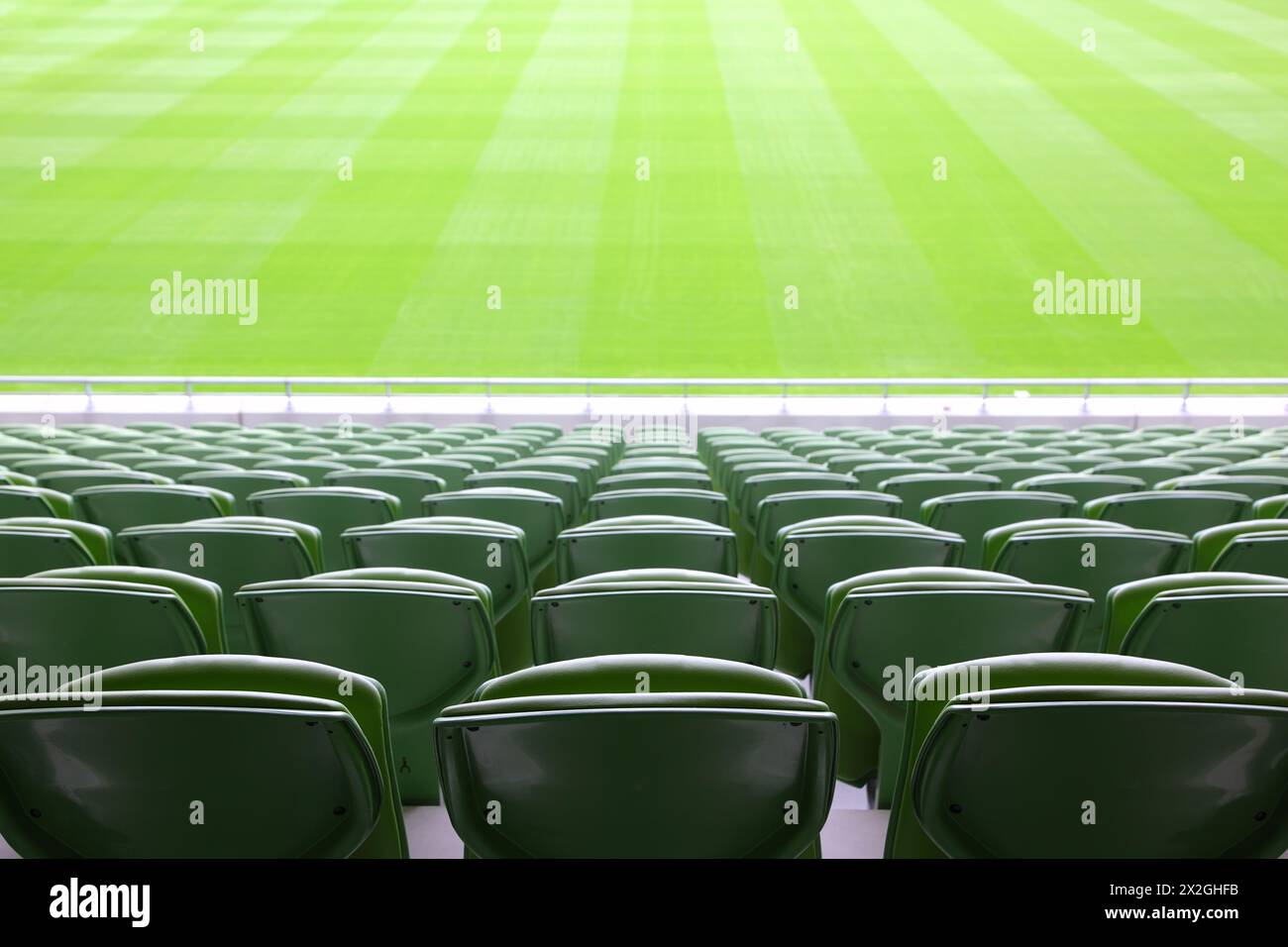 Rows of folded, green, plastic seats in very big, empty stadium Stock ...