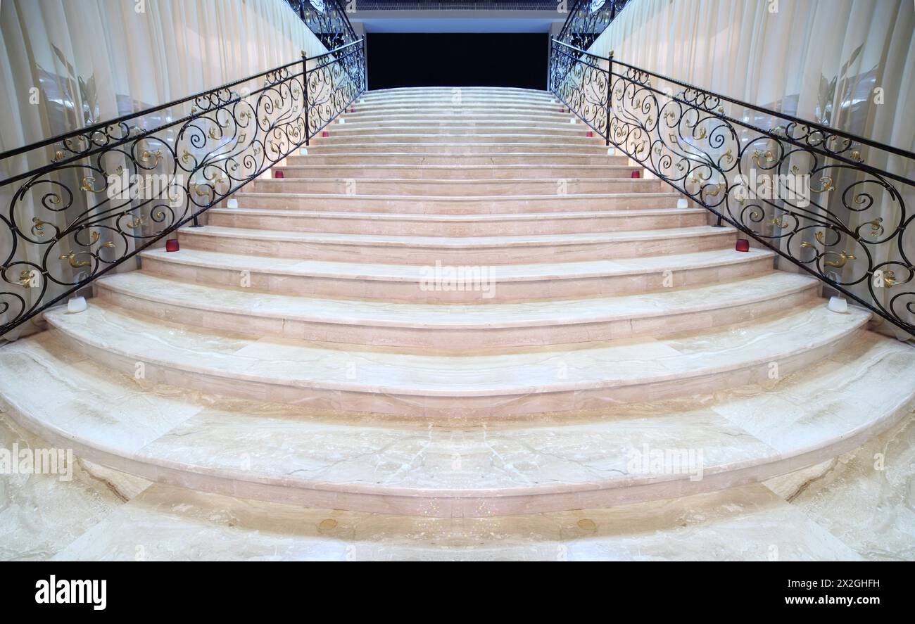 magnificent light marble staircase with ornate metal railings Stock ...
