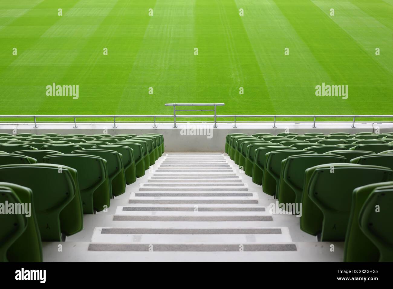 Rows of folded, green, plastic seats in very big, empty stadium Stock ...