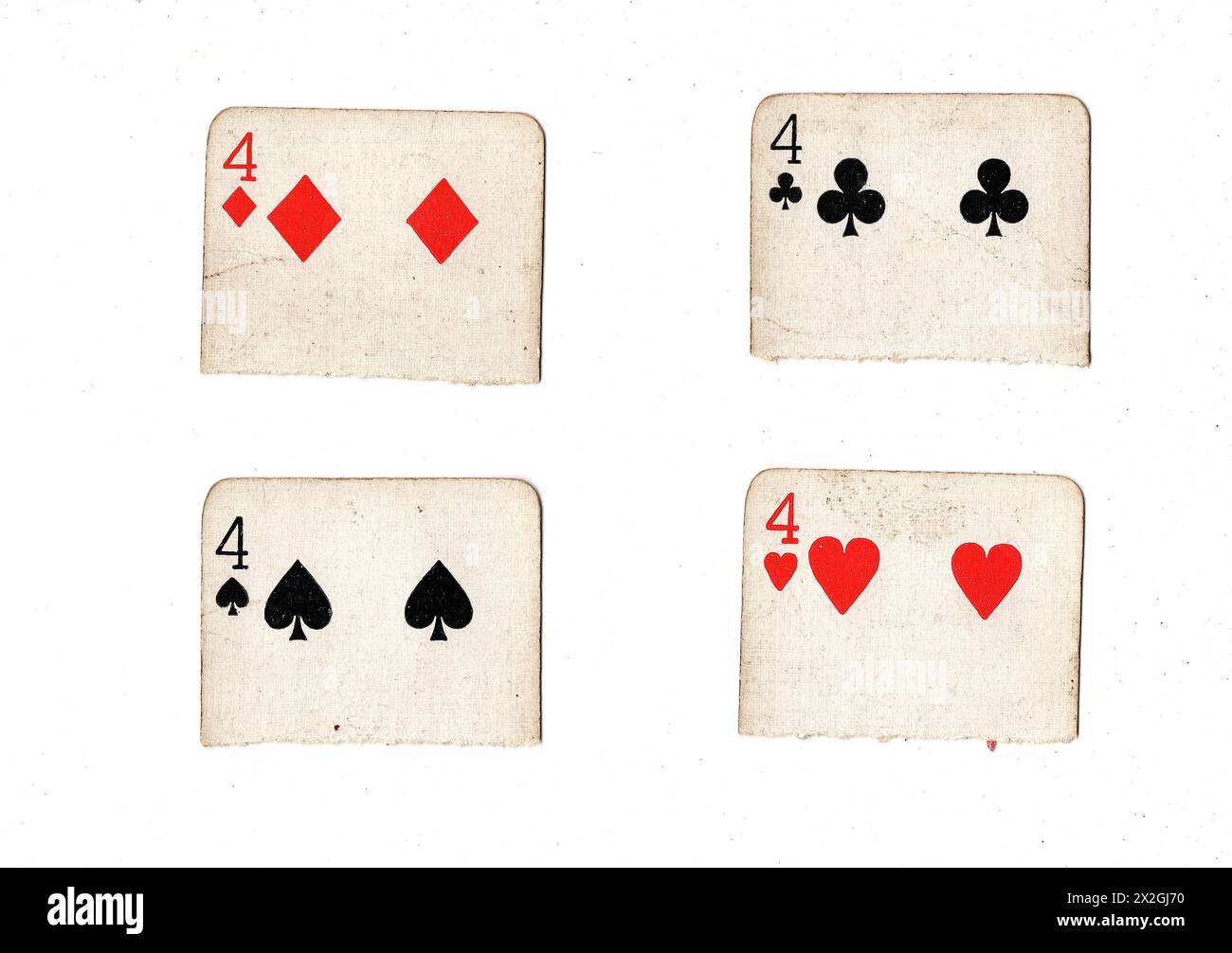 Torn halves of vintage playing cards showing a four in all four suits ...