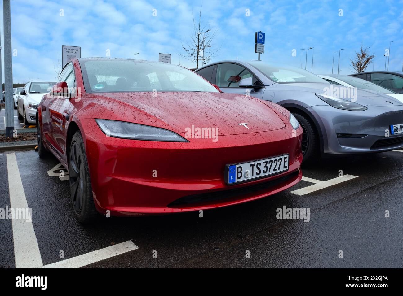 Tesla Model 3 Highland faceliftred vehicles parked in public parking ...